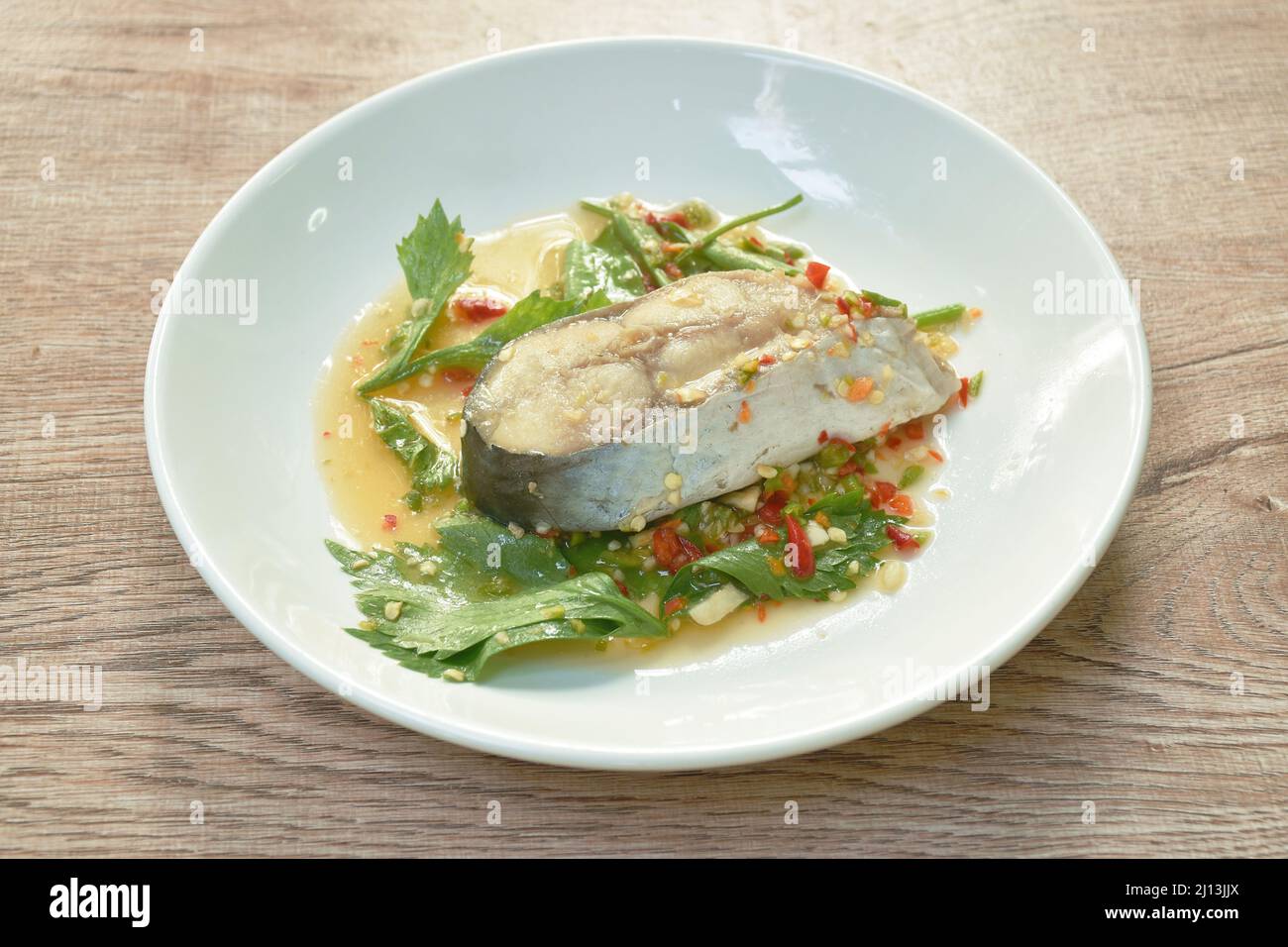 steamed dolly fish with chili and lemon dressings celery on plate Stock ...