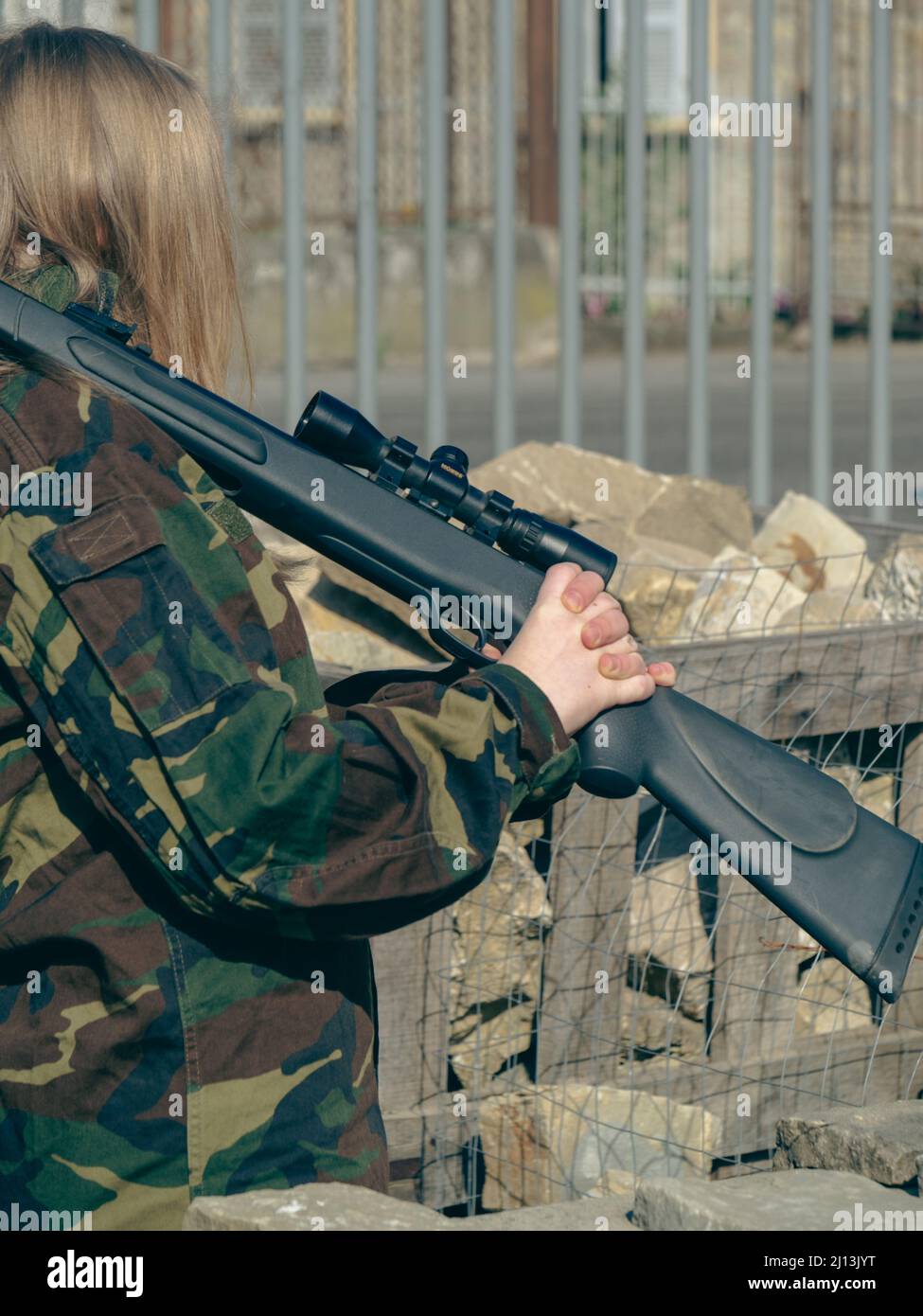 caucasian blond teen aged soldier girl on a checkpoint holding a rifle ...