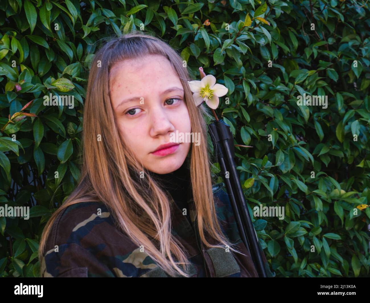 caucasian blond young teen ager soldier girl on a checkpoint holding a ...