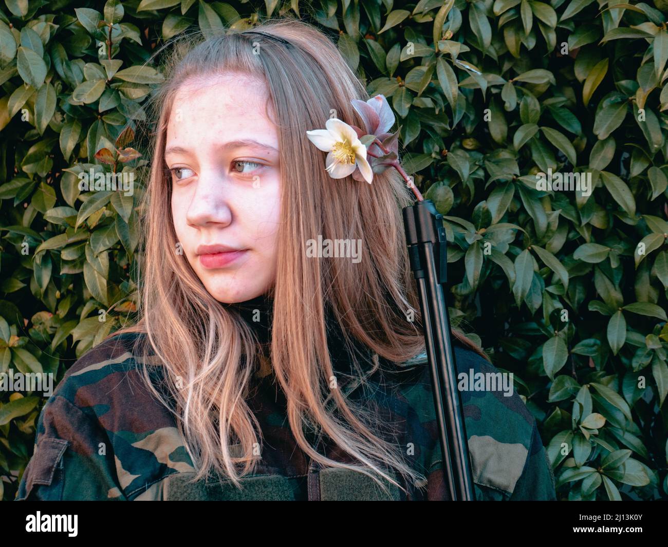 caucasian blond young teen ager soldier girl on a checkpoint holding a ...