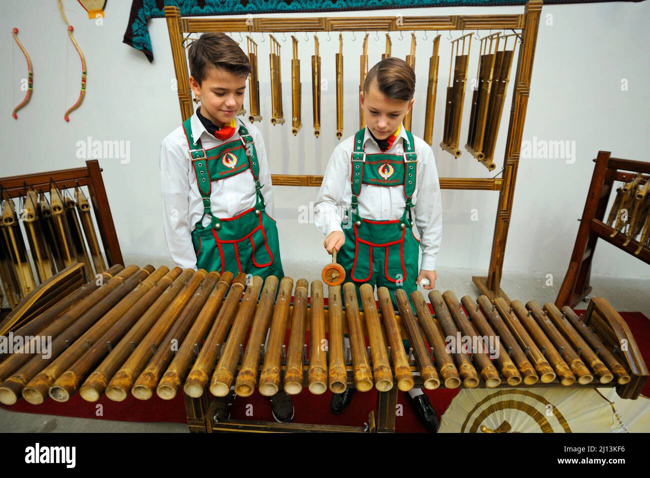 Two boys playing traditional Indonesian musical instrument. Outlook ...