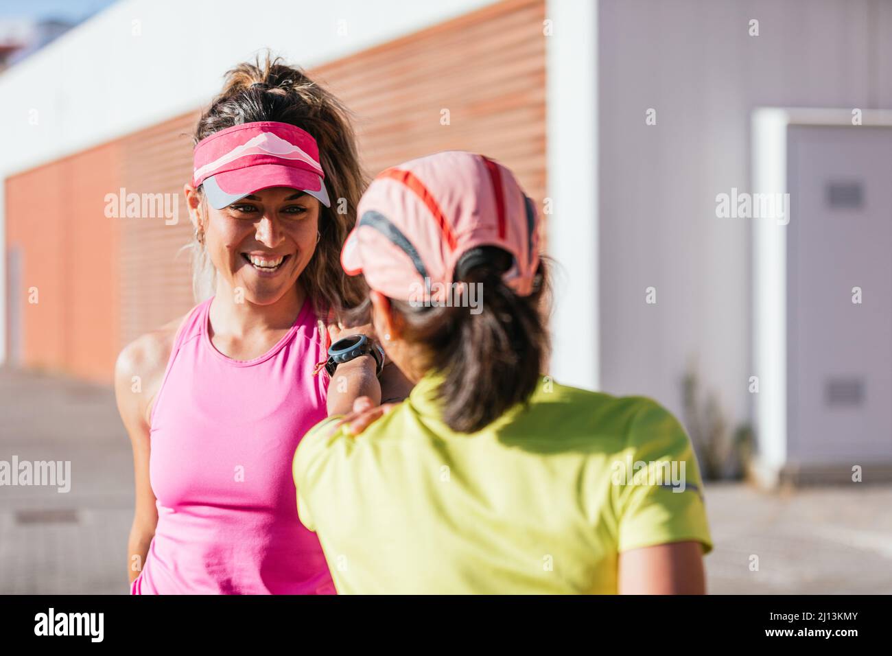 Two girls stretching together smiling. beautiful woman Stock Photo - Alamy