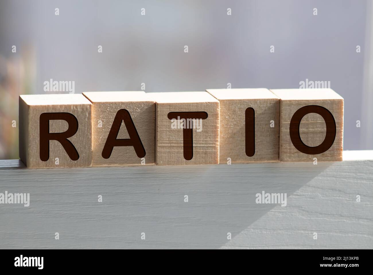 Block of alphabet letters forming the word RATIO on wooden surface ...