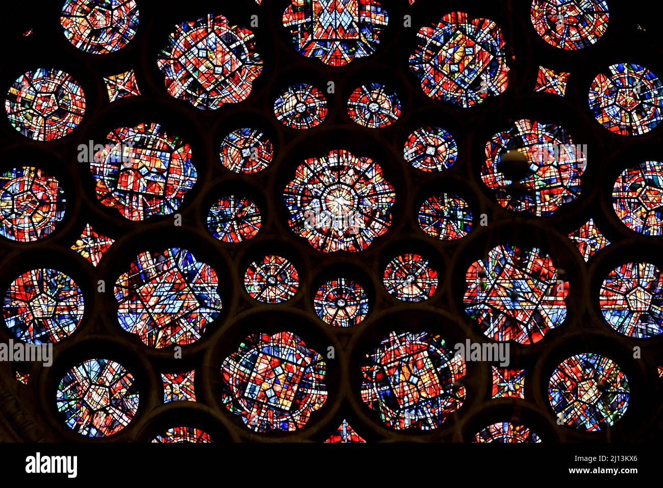 Stained glass window in a church is round with intricate circular ...
