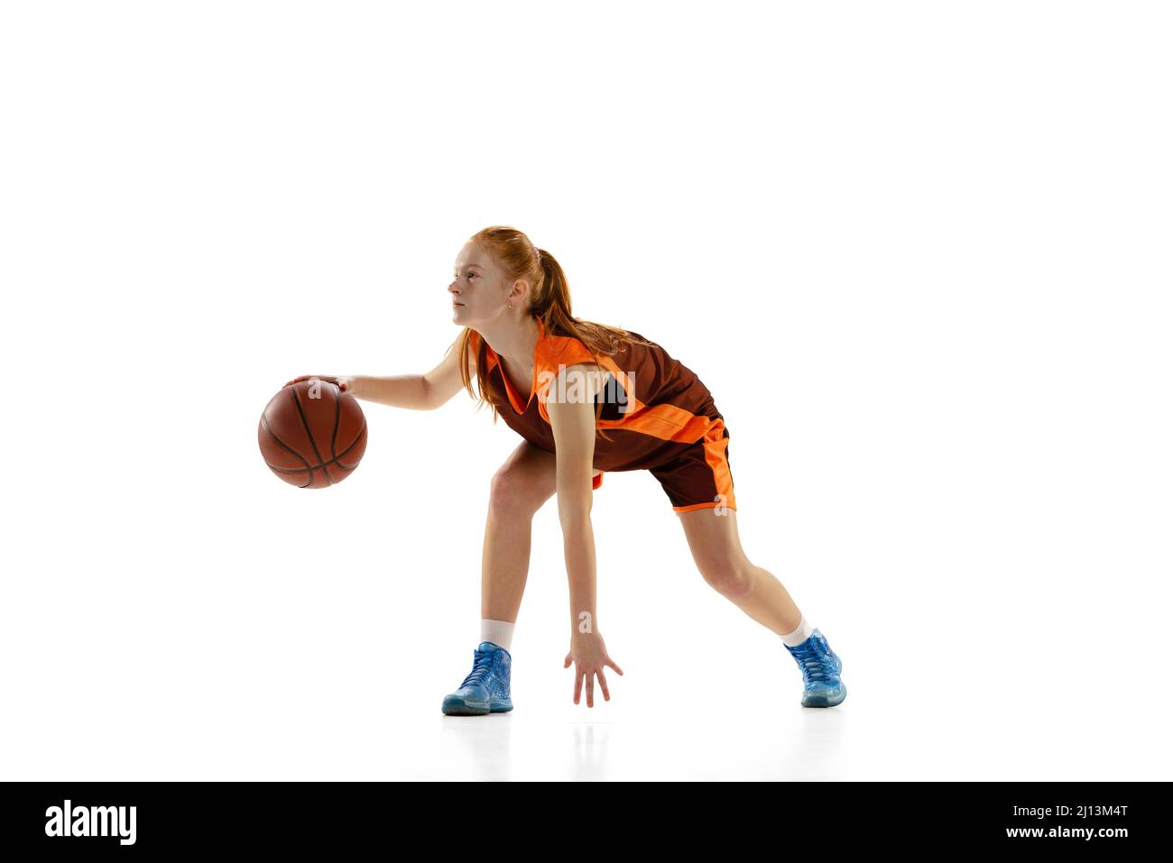 Full-length portrait of young girl, basketball player in motion ...