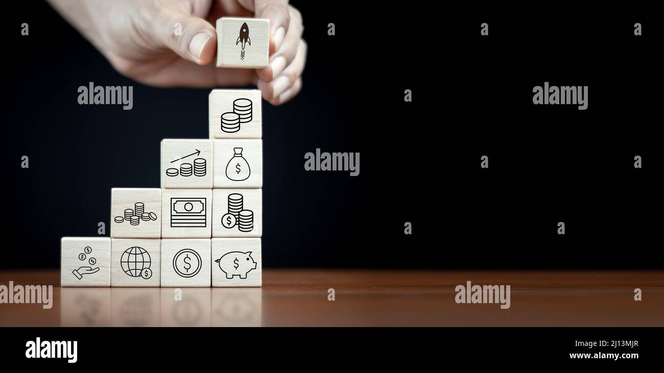 Hand placed wooden cube block of money saving icon. Banknote. Stacked ...