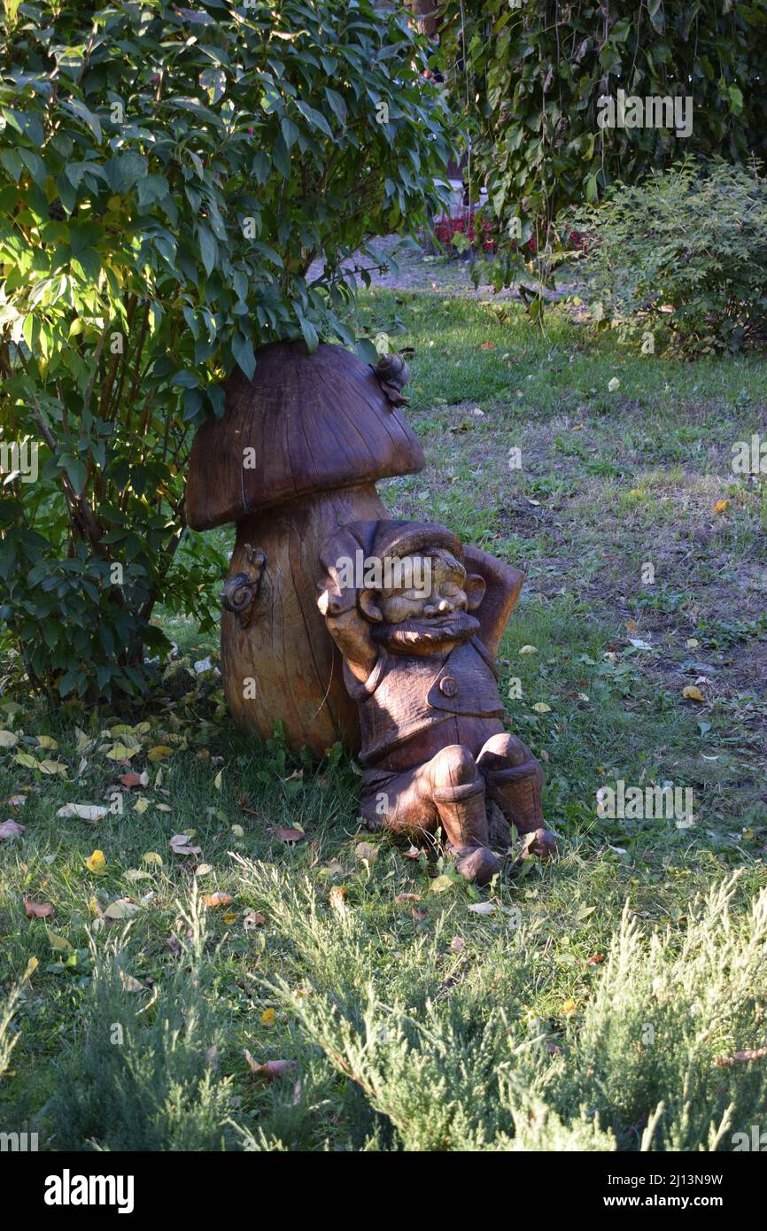 Kharkov, Ukraine, October 6, 2021. A wooden sculpture of dwarf resting ...