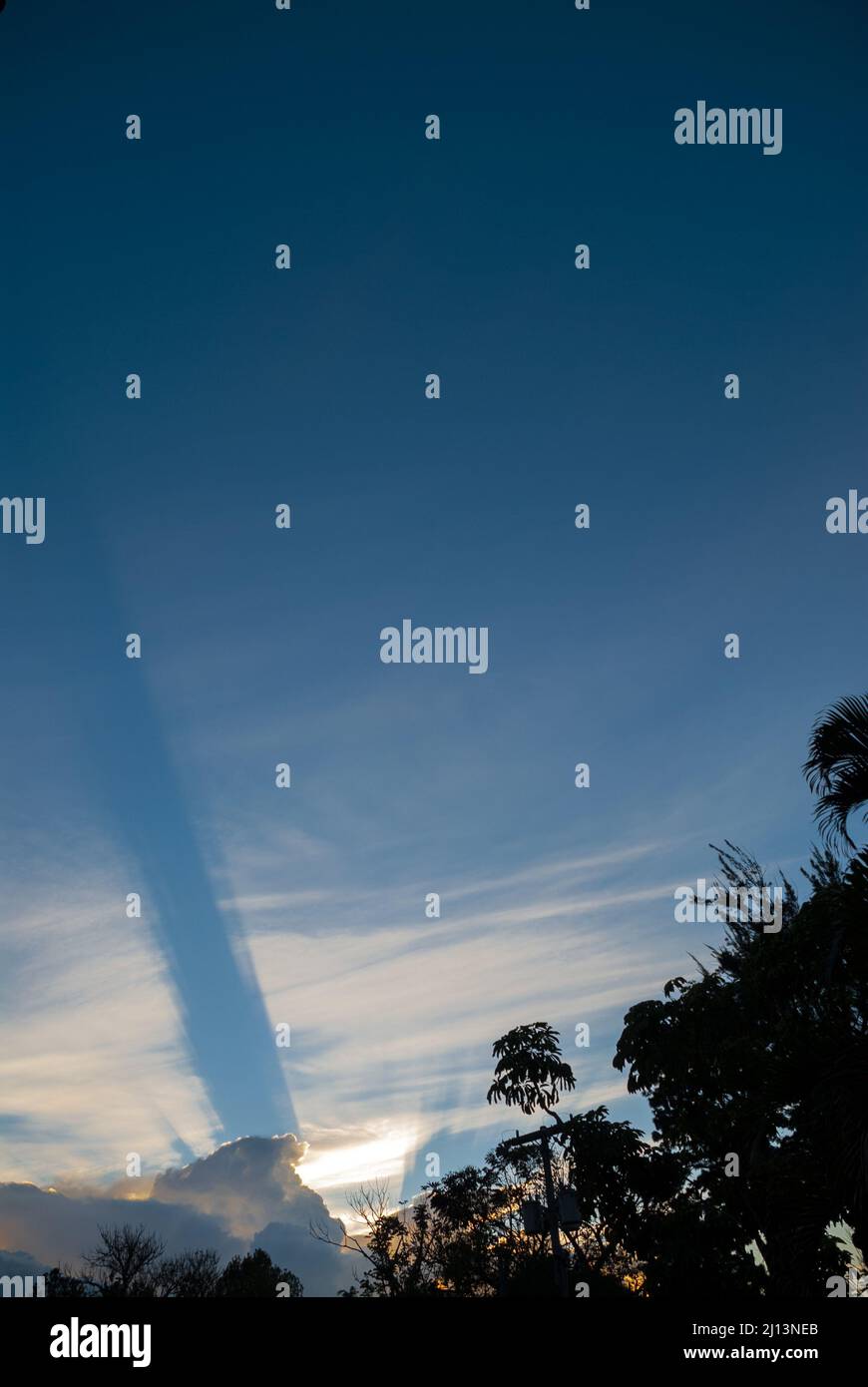 Sunset with clouds and shadows with partially clear sky, shadows cast ...