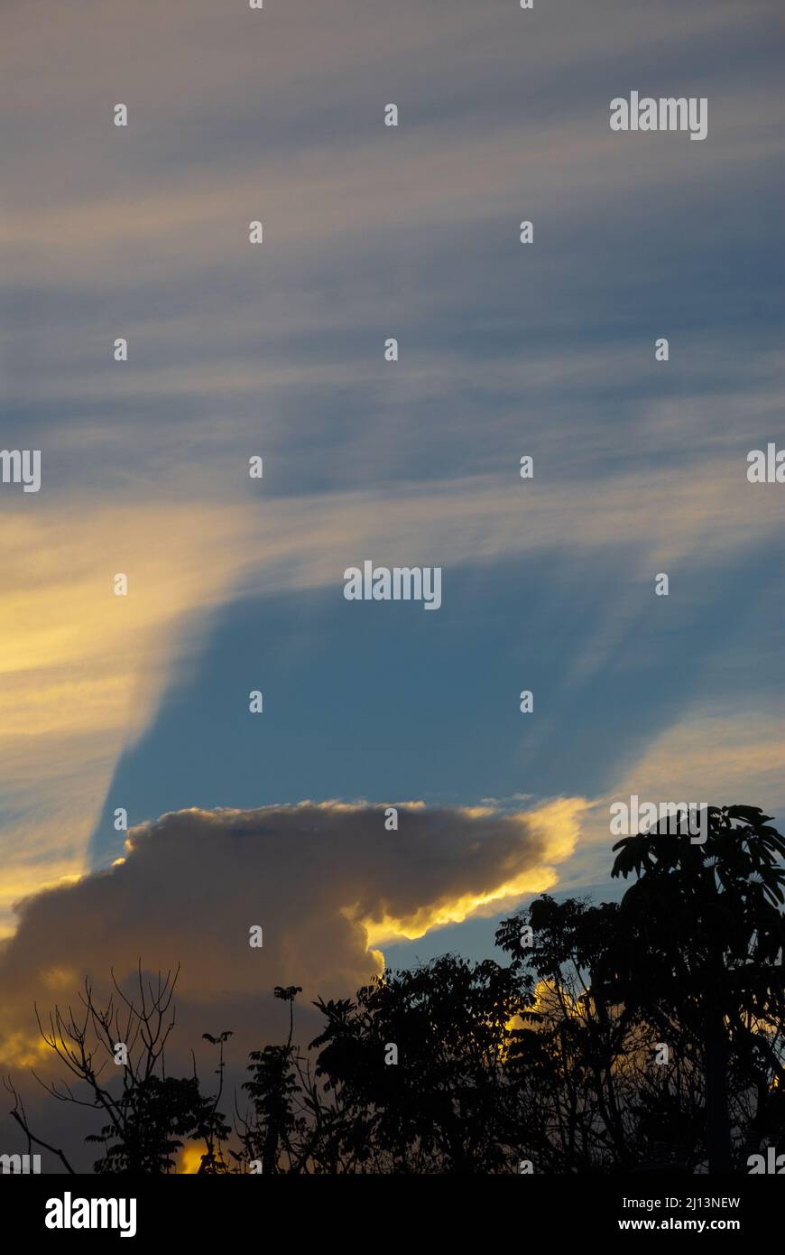 Sunset with clouds and shadows with partially clear sky, shadows cast ...
