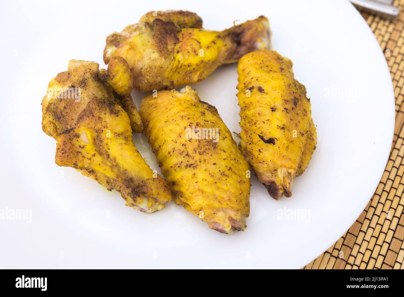 fried chicken wings on white plate Stock Photo - Alamy