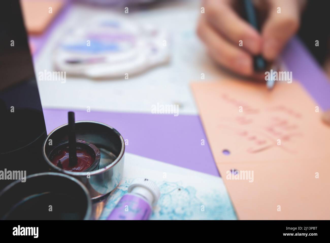 Process of calligraphy handwriting with an ink fountain pen feather ...