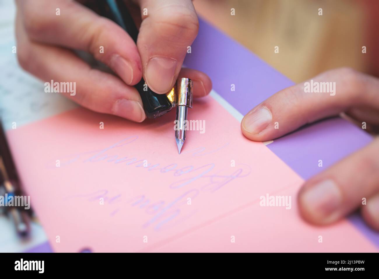 Process of calligraphy handwriting with an ink fountain pen feather ...