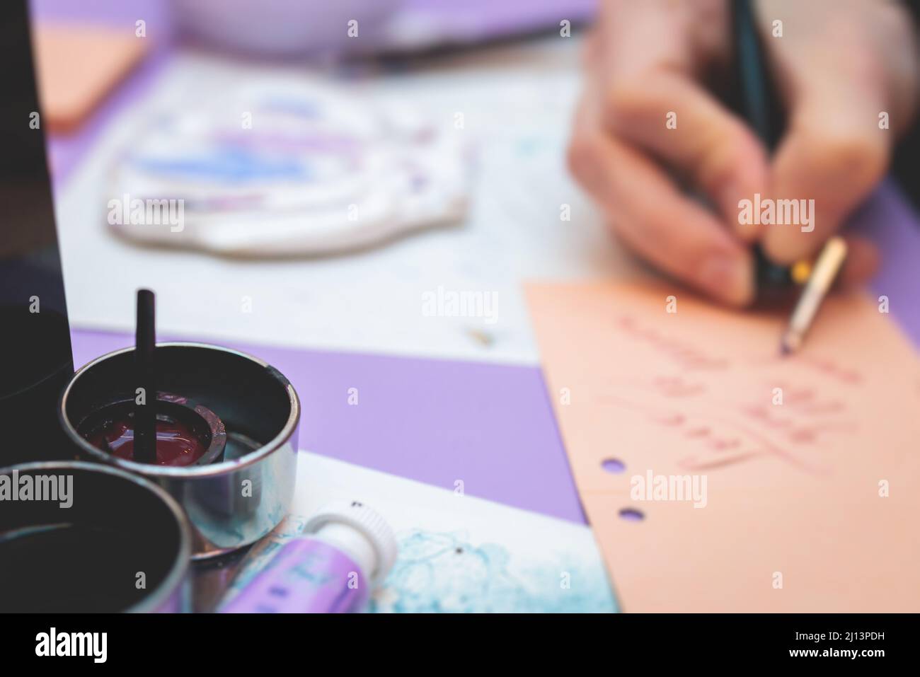 Process of calligraphy handwriting with an ink fountain pen feather ...