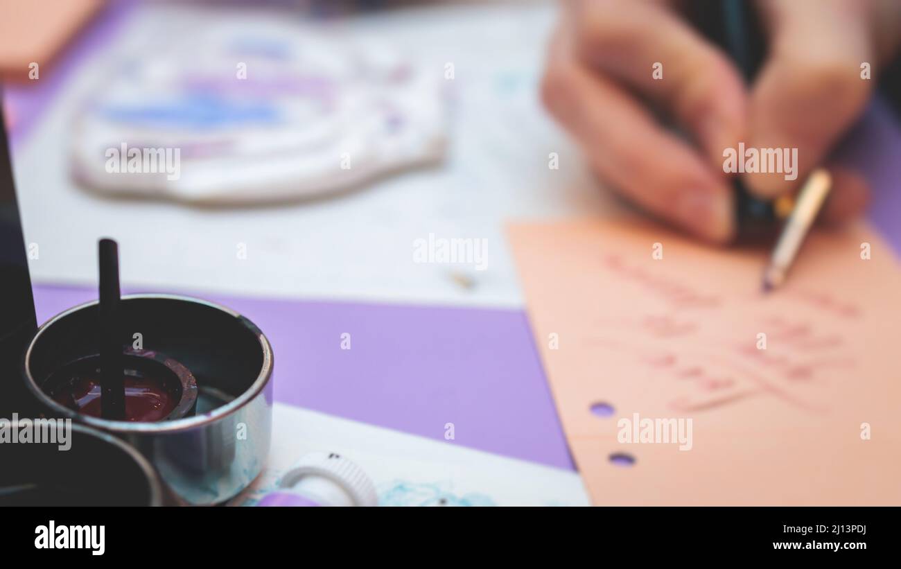 Process of calligraphy handwriting with an ink fountain pen feather ...