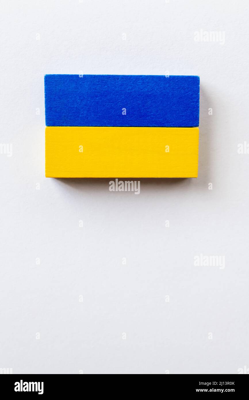top view of blue and yellow blocks on white background with copy space ...
