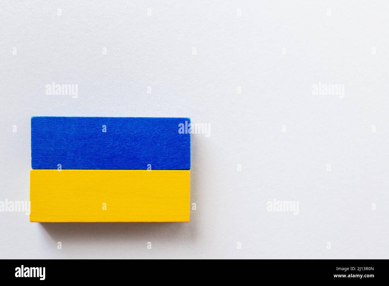 top view of blue and yellow blocks on white background, ukrainian ...