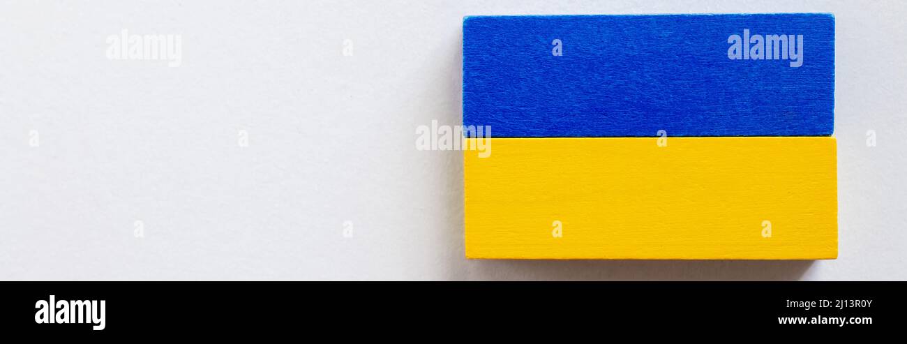 top view of tetragonal blue and yellow blocks on white background ...