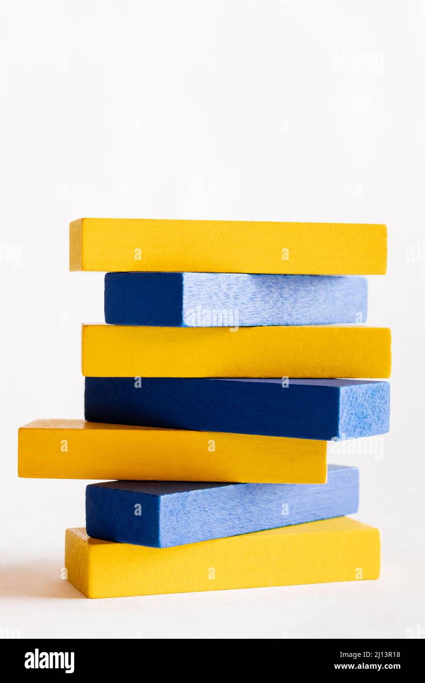 stack of blue and yellow blocks on white background, ukrainian concept ...