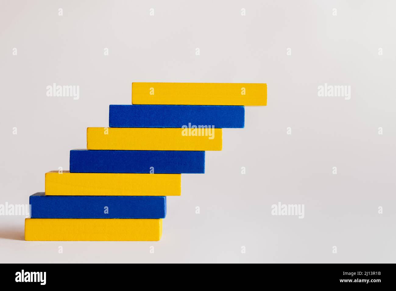blue and yellow blocks stacked on white background, ukrainian concept ...