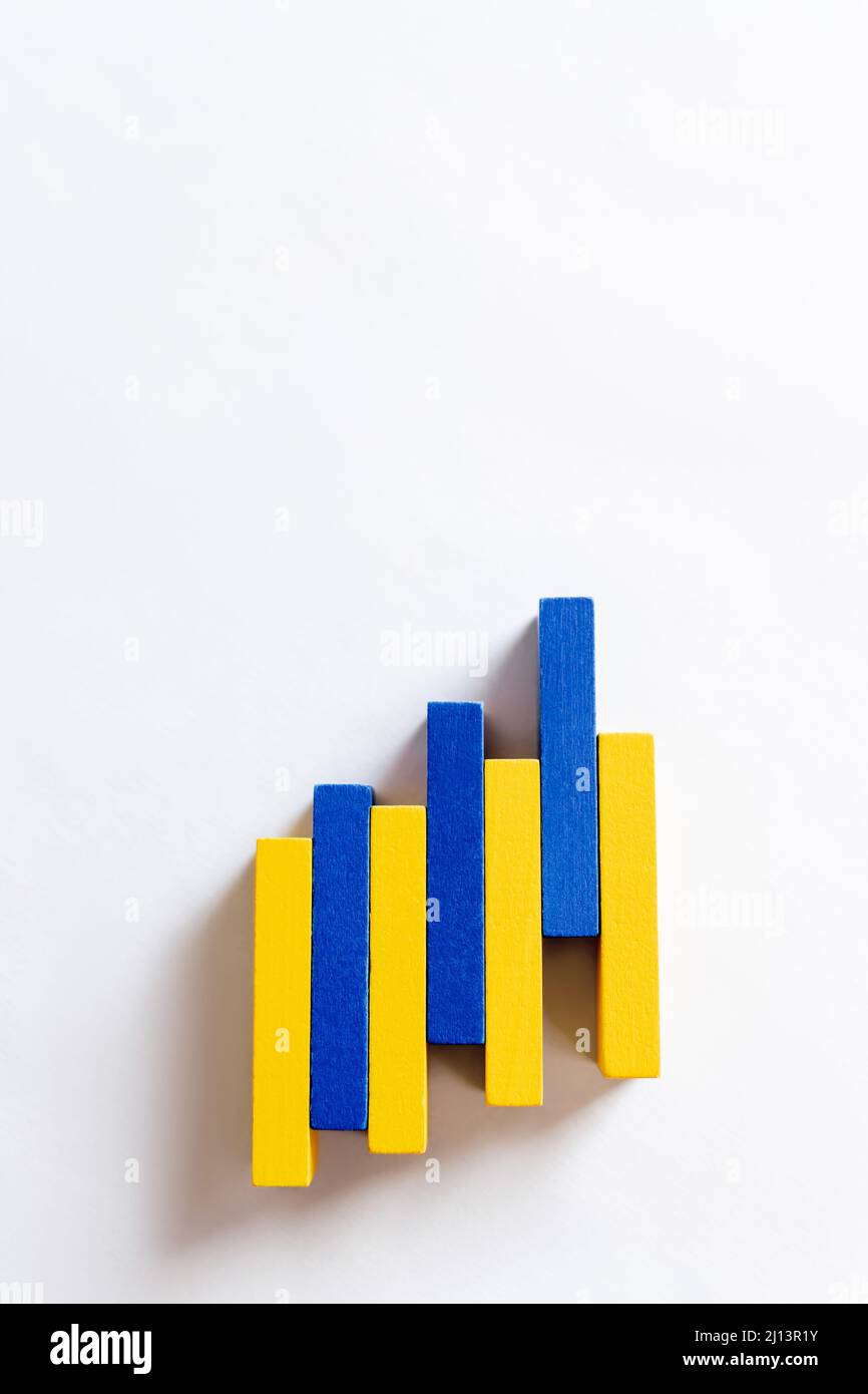 top view of colorful blue and yellow blocks on white background with ...