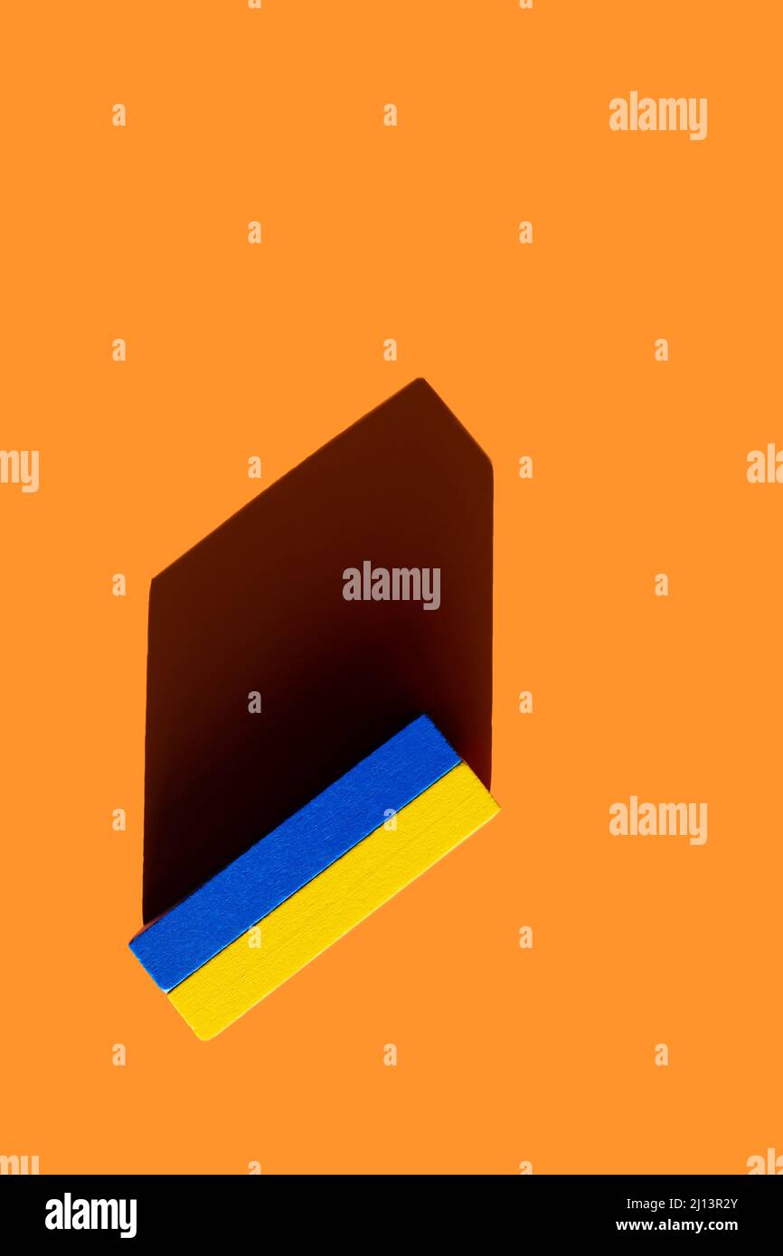 top view of bright blue and yellow blocks on orange background ...
