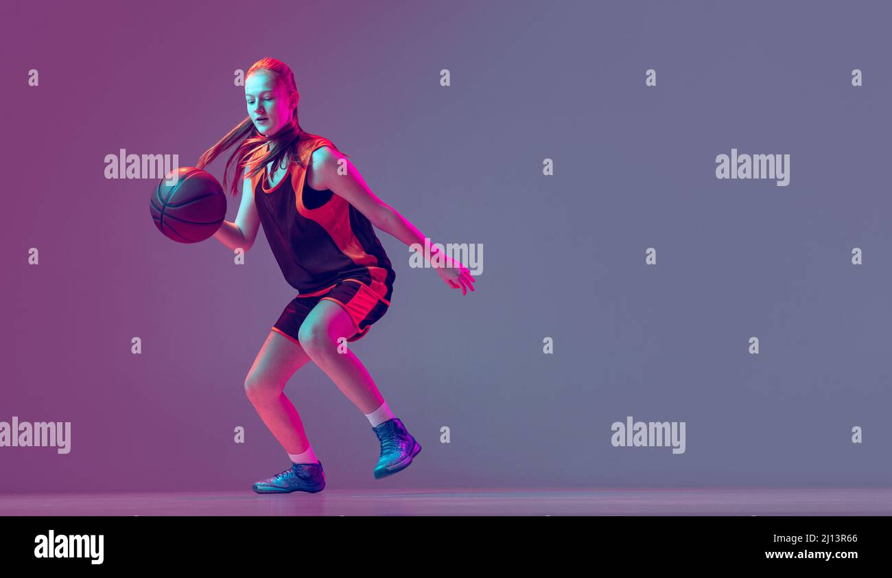 Portrait of young girl, basketball player in motion, training isolated ...