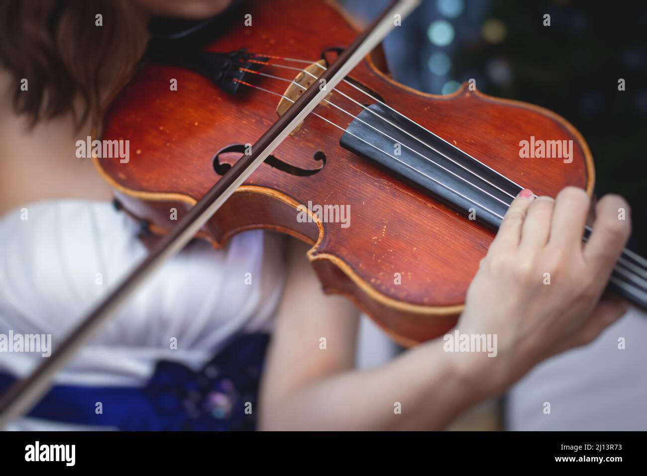 Female violin player, fiddler violinist with a bow performing music on ...