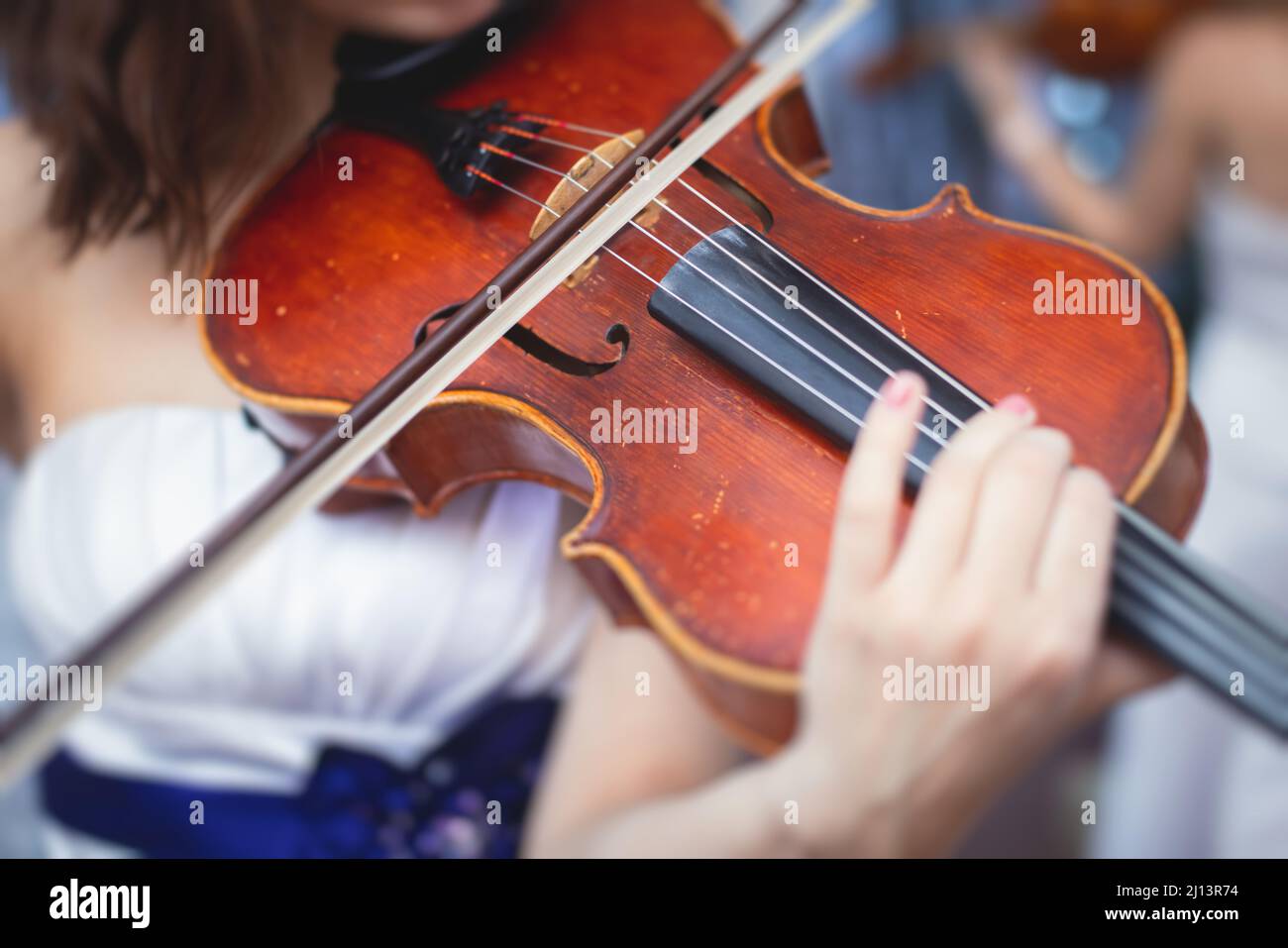 Female violin player, fiddler violinist with a bow performing music on ...