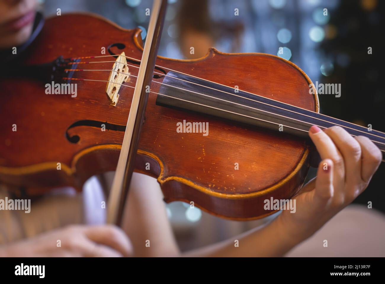 Female violin player, fiddler violinist with a bow performing music on ...
