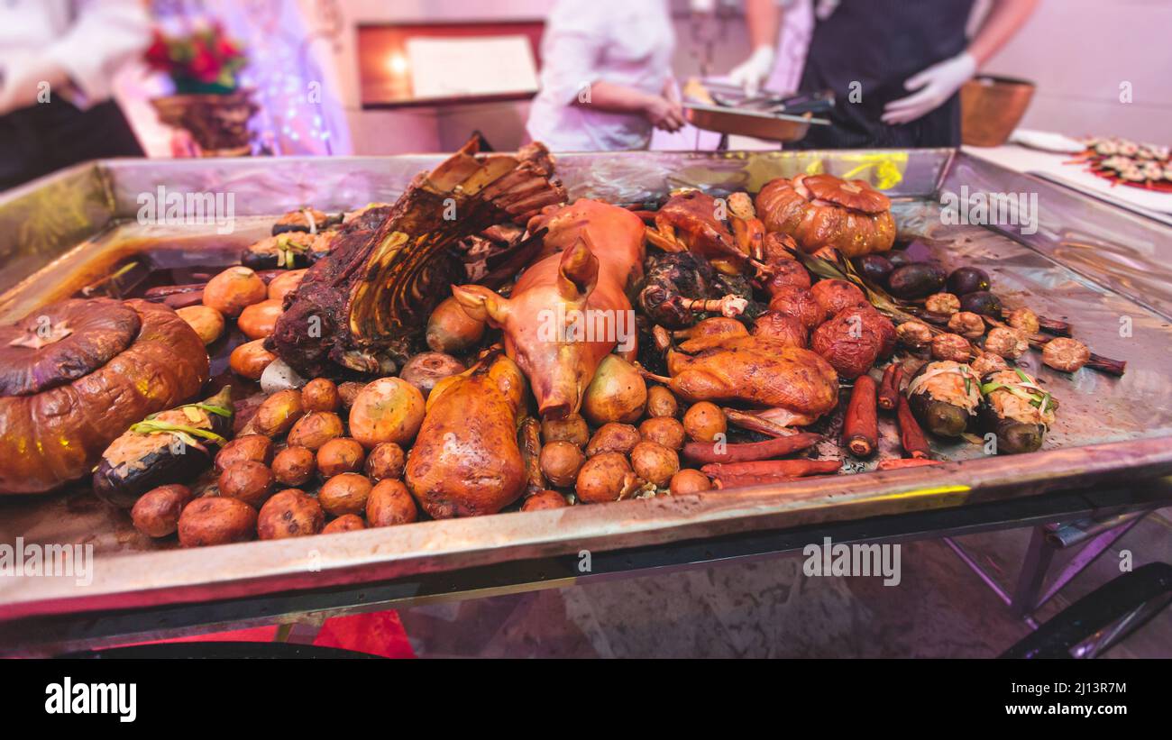 Big giant dish plate with a roasted full pig pork head, served in ...