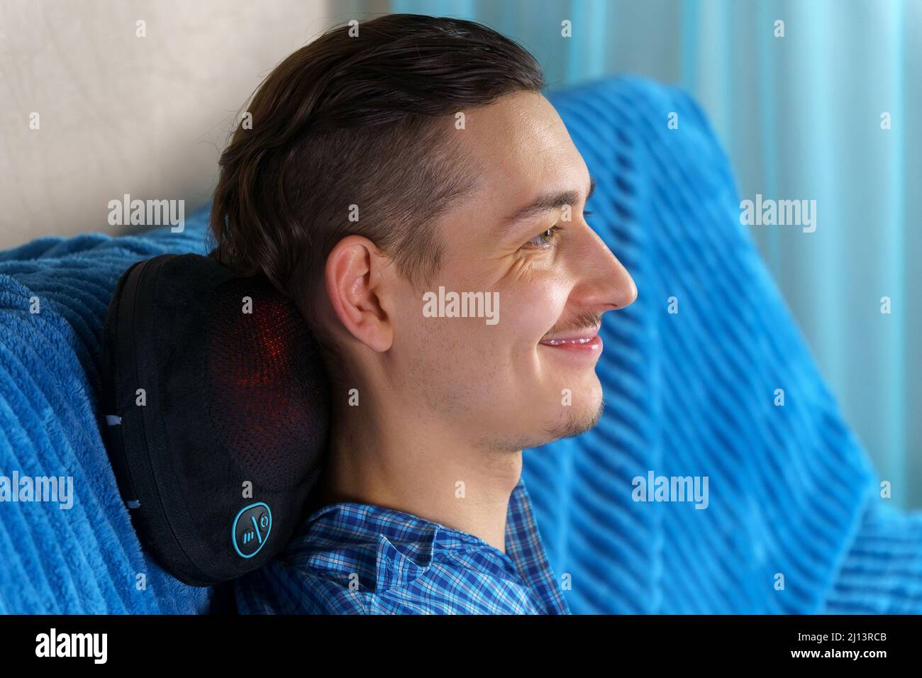 A man massages neck with a massage pillow, body feel more relaxed Stock ...