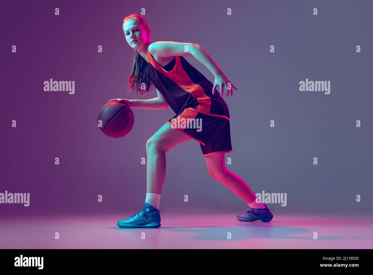 Portrait of young girl, teen, basketball player in motion, training ...