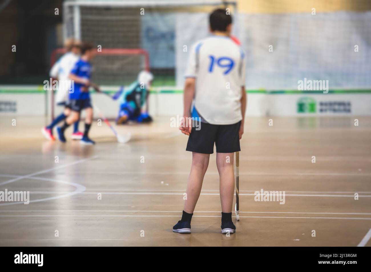 View of floorball match game, court hall indoor venue with junior ...