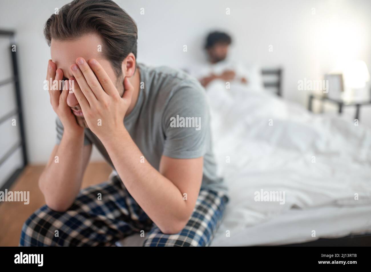 Dark-haired Caucasian man suffering from the break-up Stock Photo - Alamy