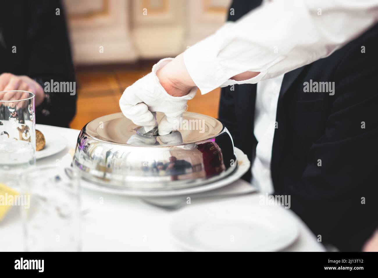 Process of serving luxury dinner in a cloche plate dish with a lid ...