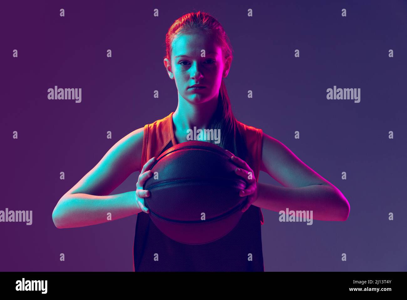Half-length portrait of young sportive girl, teenager, basketball ...
