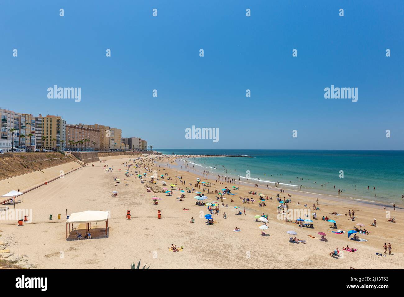 View of famous beach "Playa de Santa María del Mar". People enjoying a ...