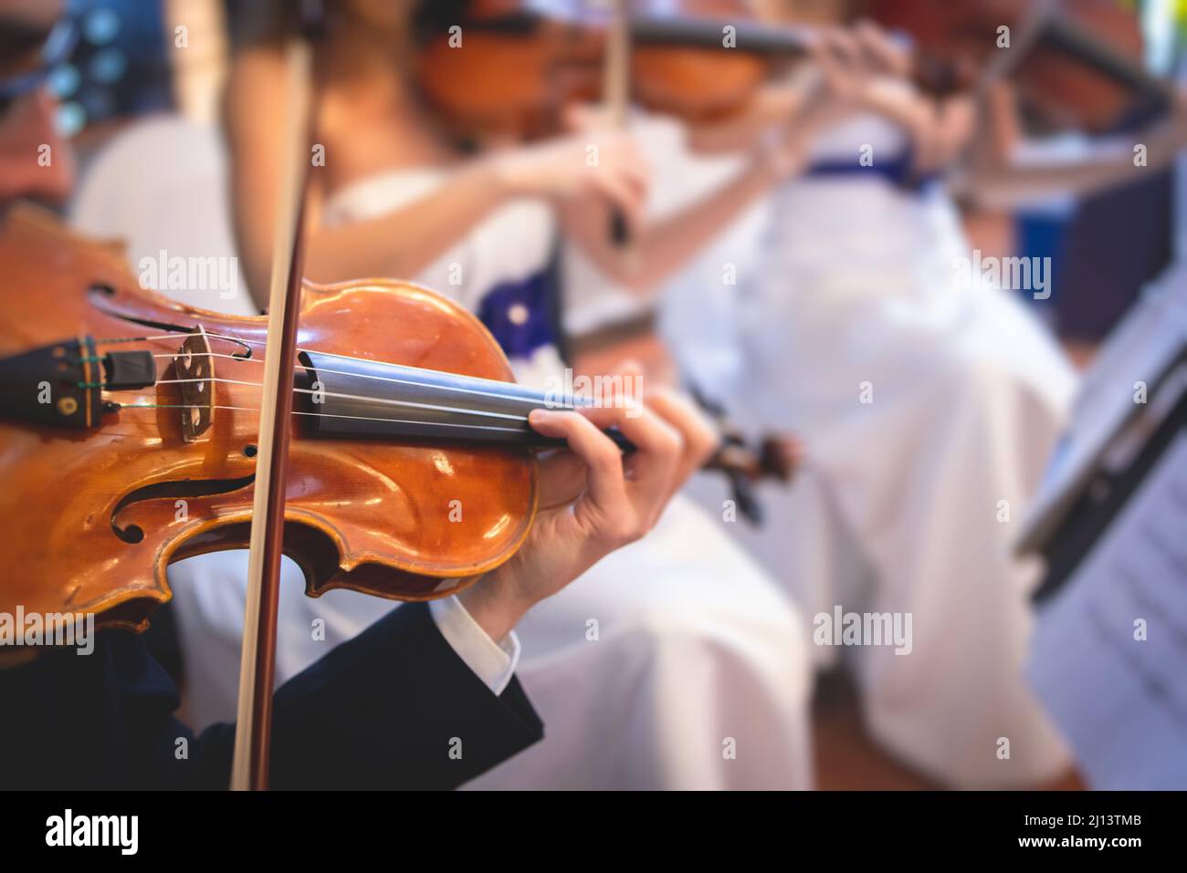 Male violin player, fiddler violinist with a bow performing music on a ...