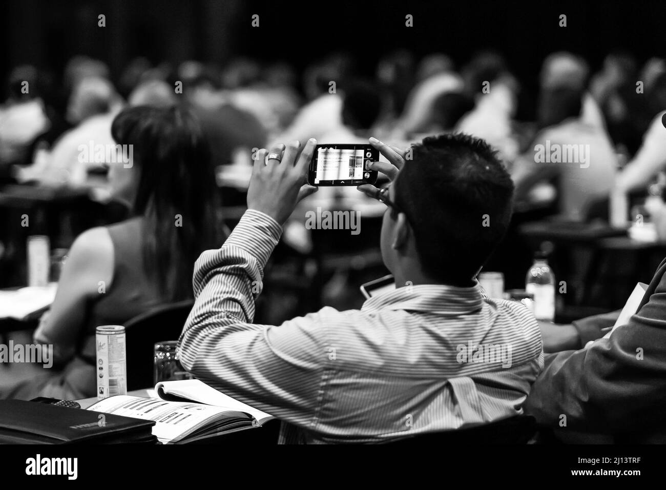 Delegates attending a sales convention in large conference hall Stock ...