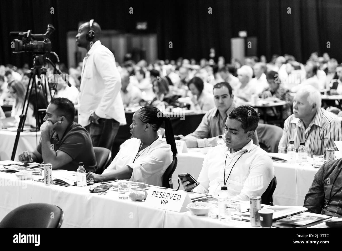 Delegates attending a sales convention in large conference hall Stock ...