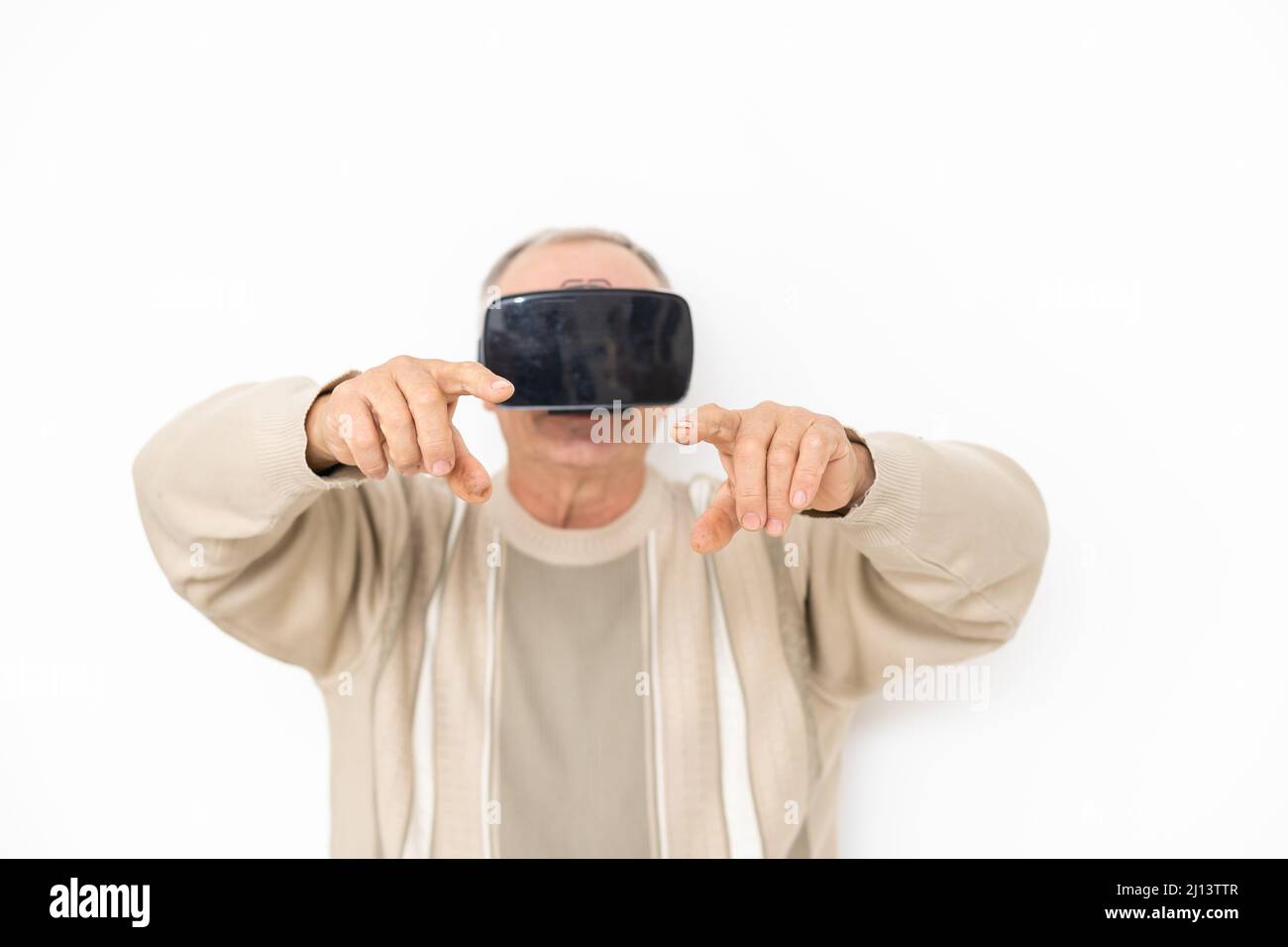 Senior man playing video game on white background Stock Photo - Alamy