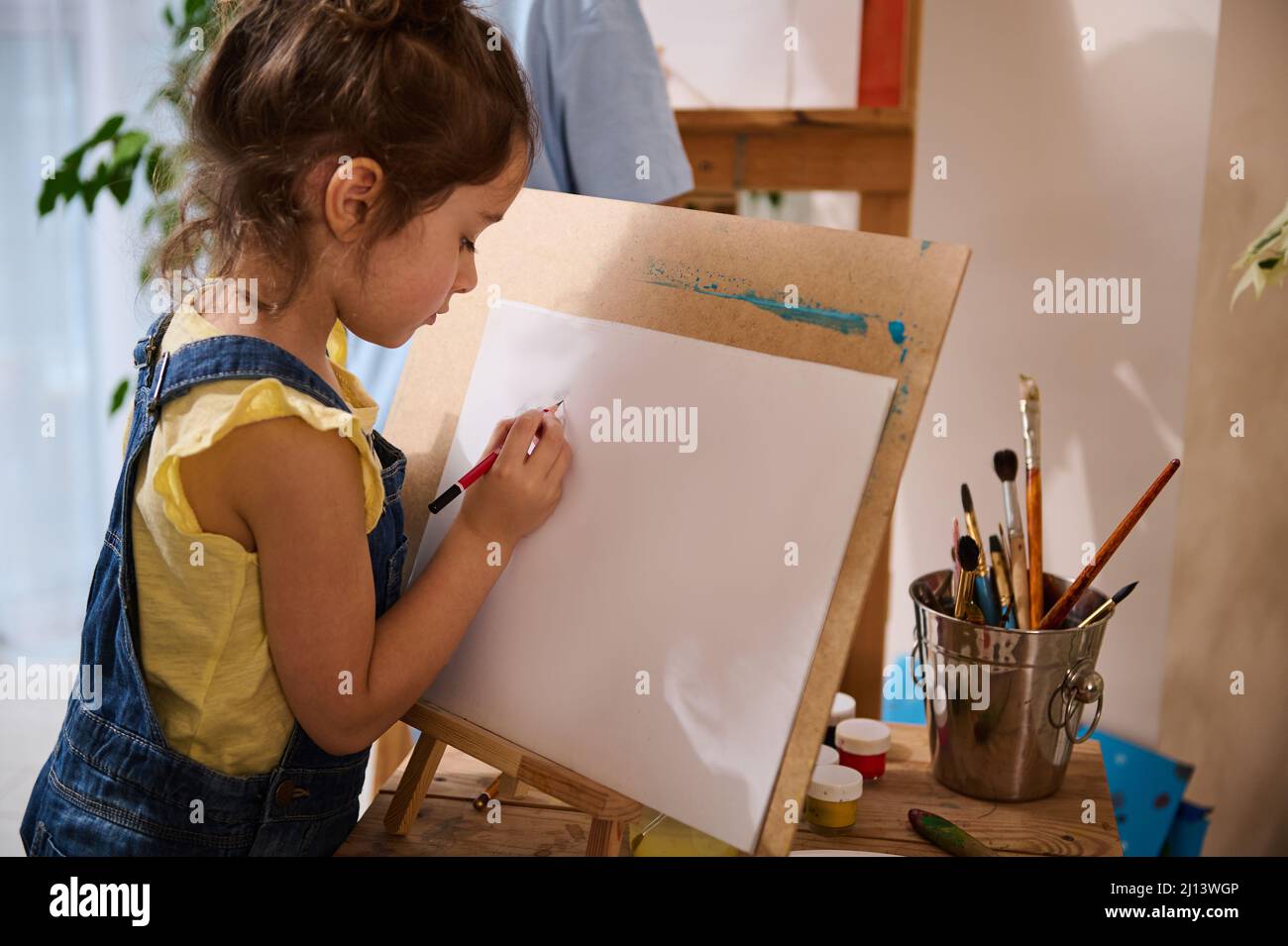 Adorable sweet baby girl, talent Caucasian child drawing picture on ...