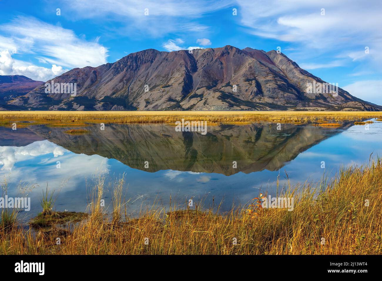 Sheep Mountain in autumn reflected in Kluane Lake, in Kluane National ...