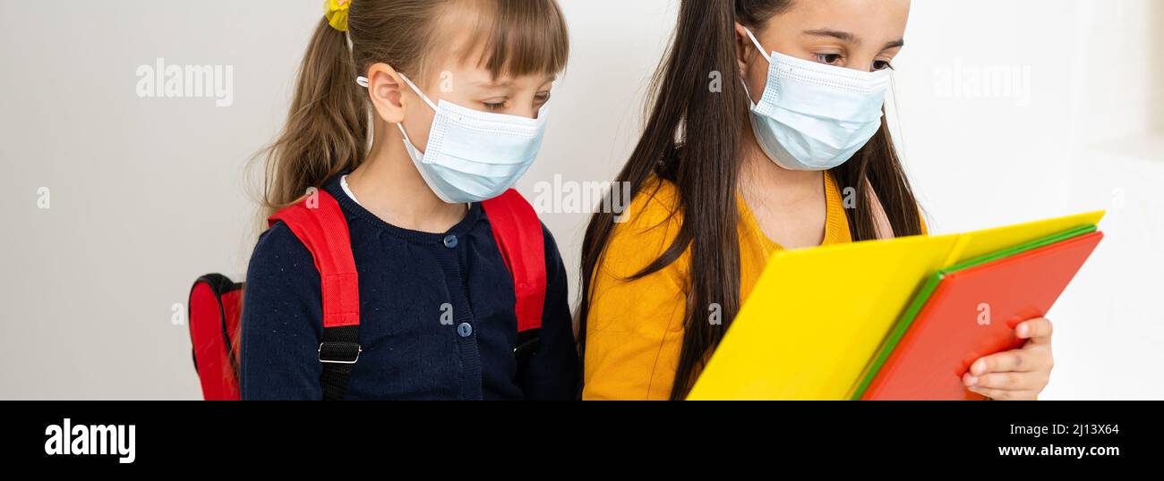 Close-up portrait of two nice attractive girls wearing safety mask ...
