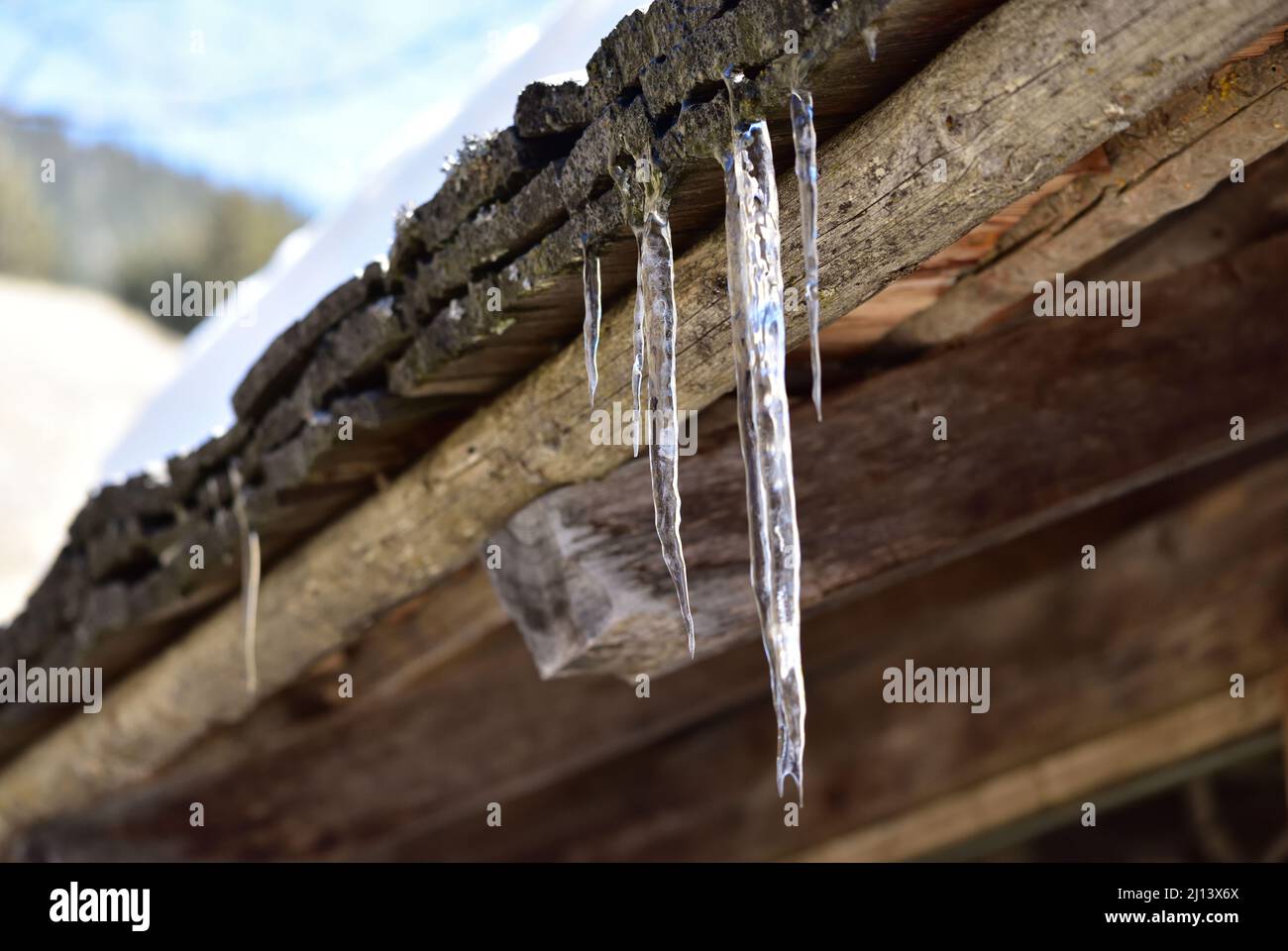 The still cold air forms icicles as the snow melts on the roof of the ...