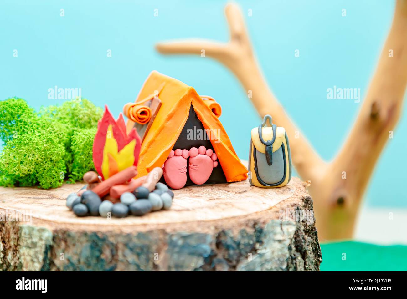 Tourist camp. Plasticine landscape with a tent, a campfire and a ...