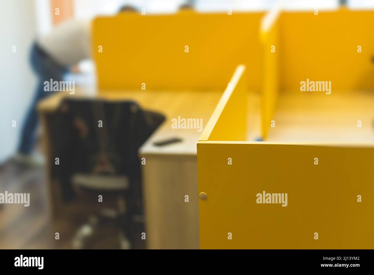 View of modern office space interior with desks in yellow tones with ...