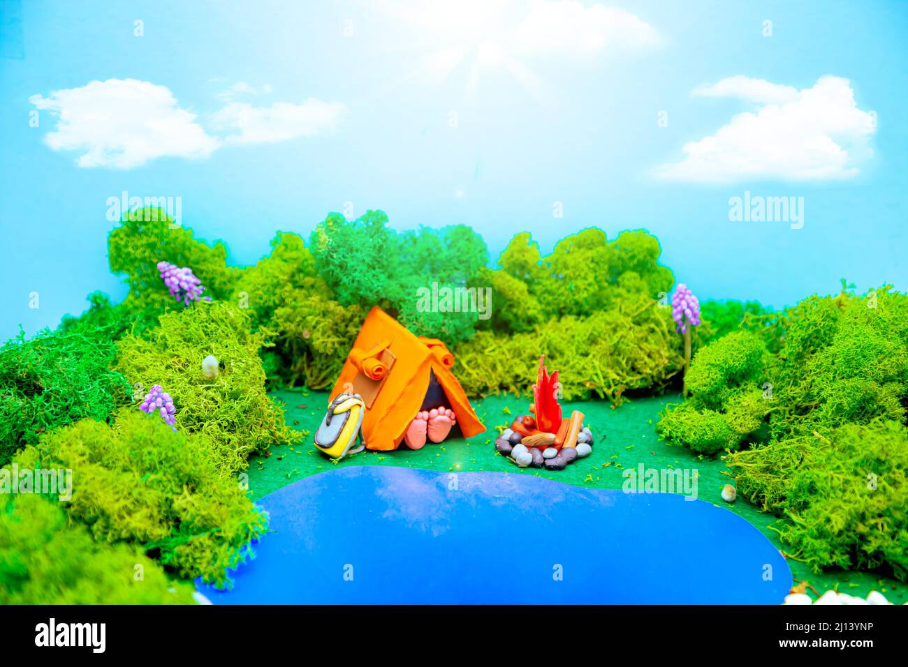 Tourist camp. Plasticine landscape with a tent, a campfire and a ...
