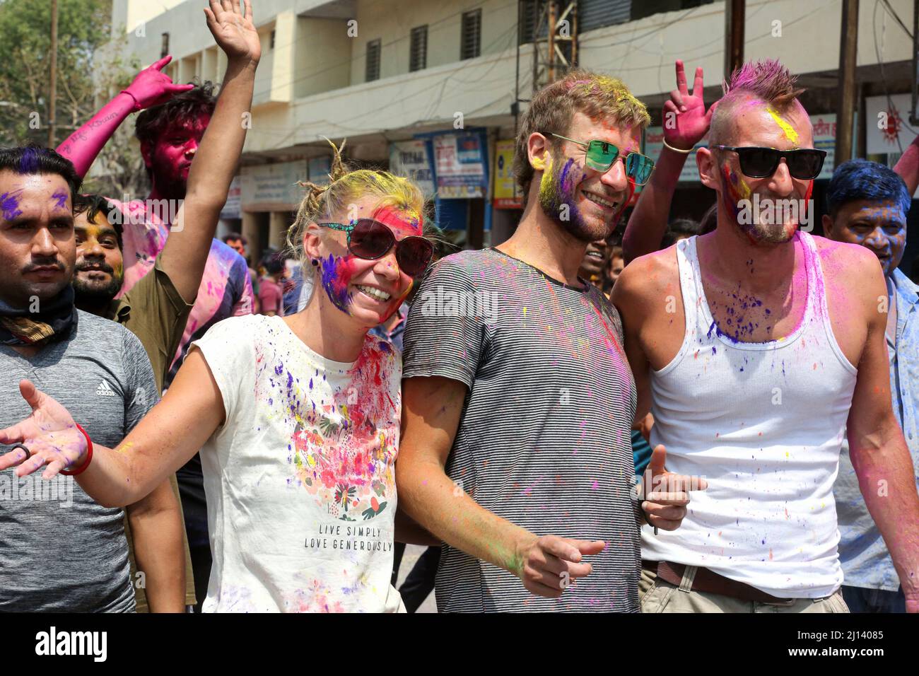 Indore, India. 22nd Mar, 2022. Revelers with coolers painted on their ...