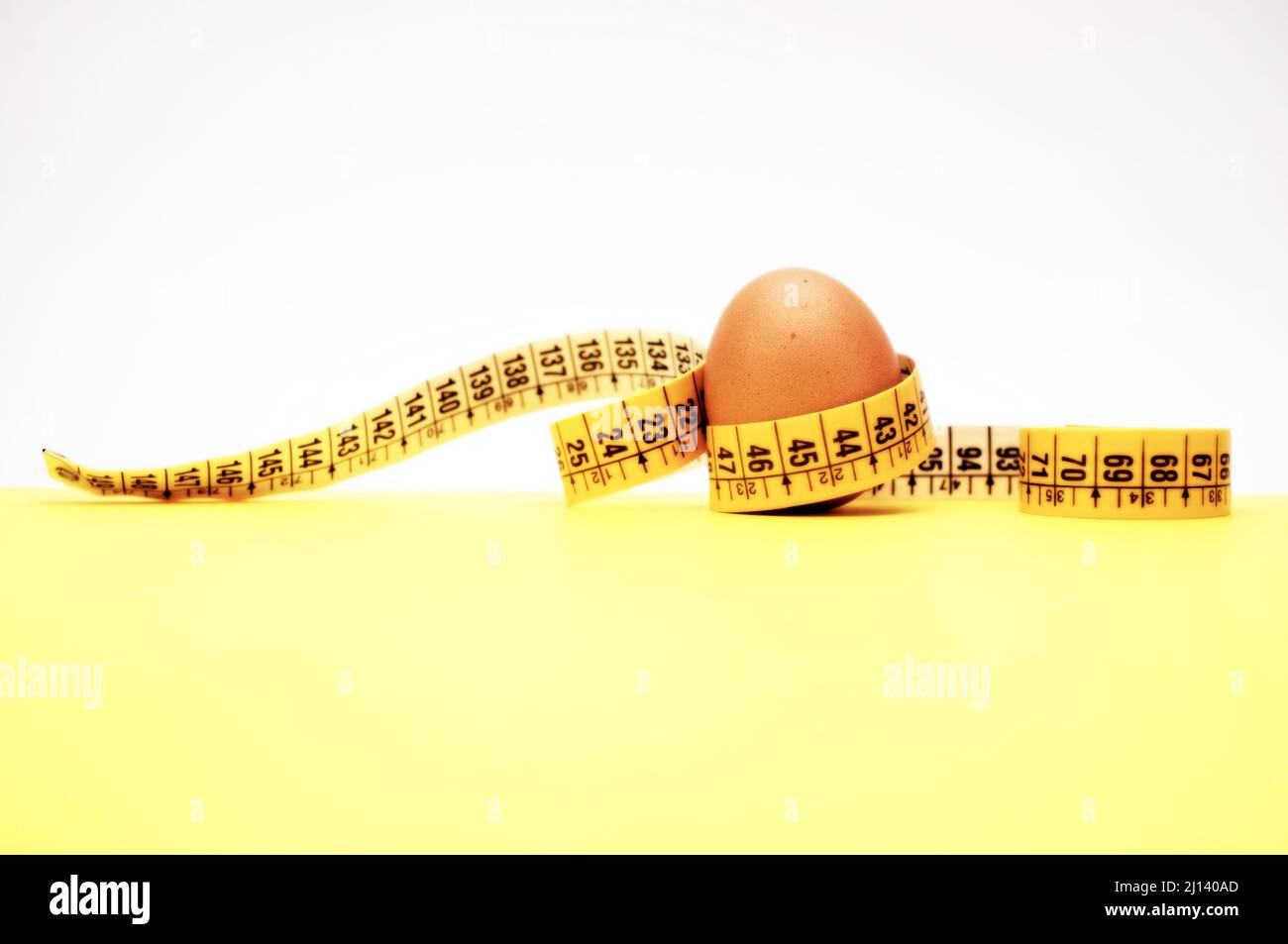 Healthy nutrition and fit concept - organic brown egg wrapped in a ...